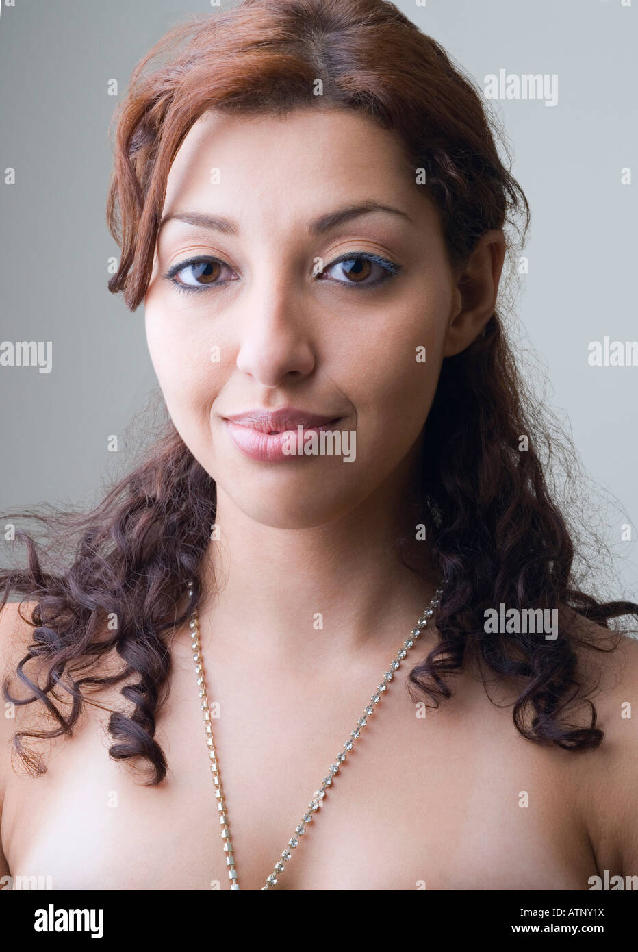 Portrait of a young woman smirking Stock Photo - Alamy