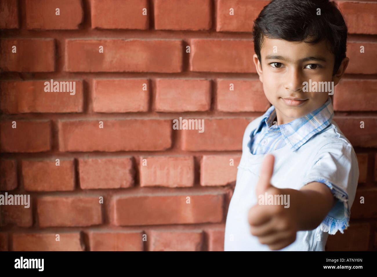 Portrait of a boy making a thumbs up sign Stock Photo - Alamy