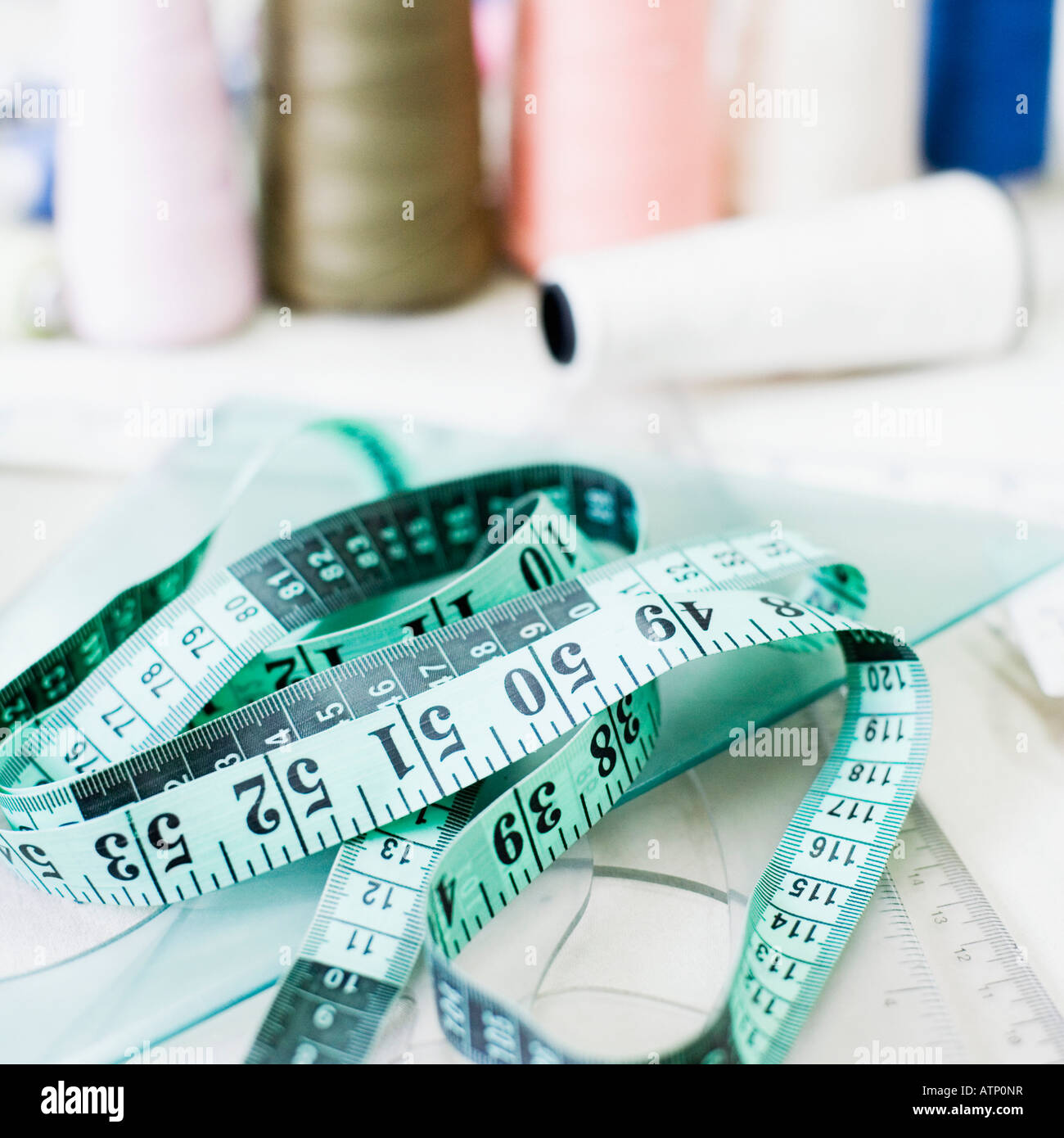 Close-up of a tape measure with spools of thread Stock Photo - Alamy