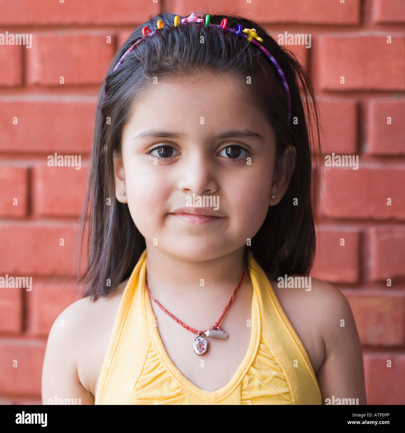 Portrait of a girl standing in front of a wall Stock Photo - Alamy