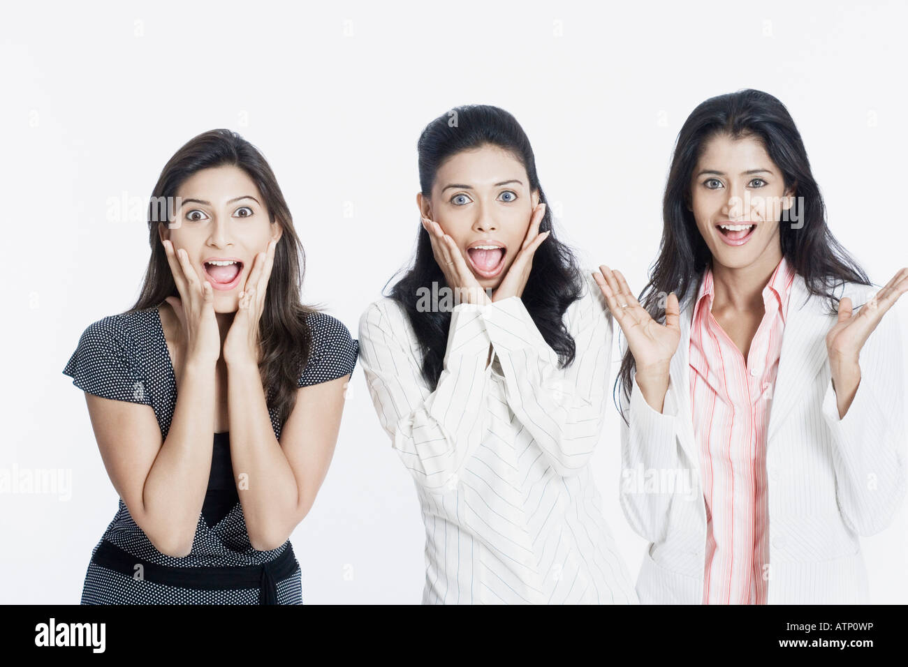 Portrait of three young women looking surprised Stock Photo - Alamy