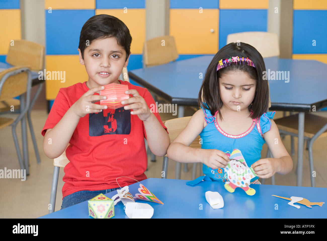 Two students making paper craft products in a classroom Stock Photo - Alamy