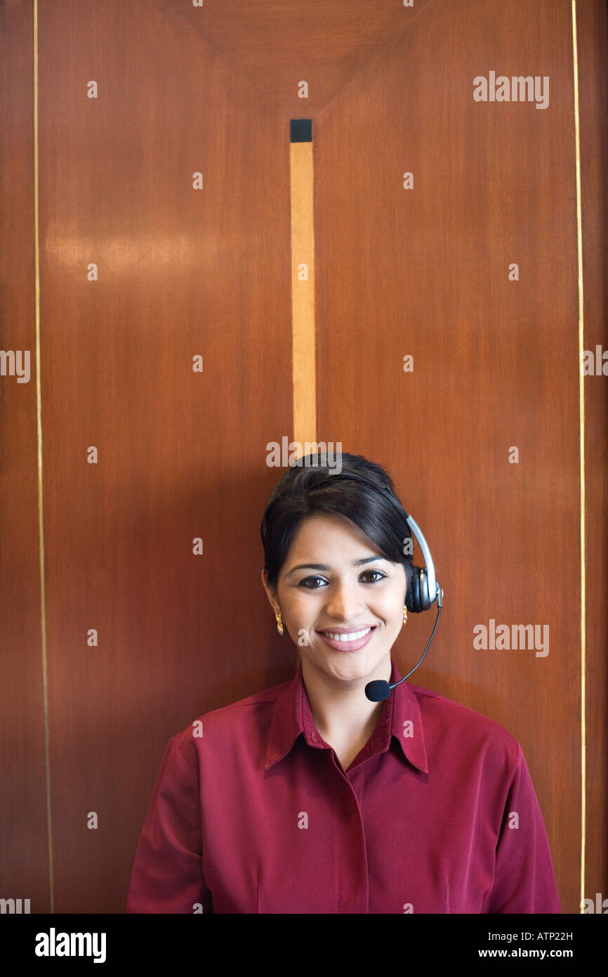 Portrait of a female customer service representative wearing a headset ...
