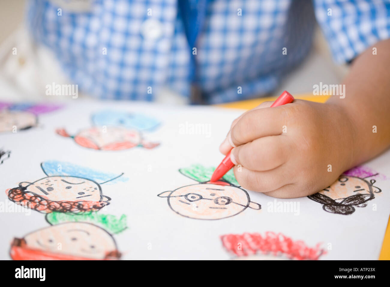 Close-up of child's hand drawing on a sheet of paper Stock Photo - Alamy