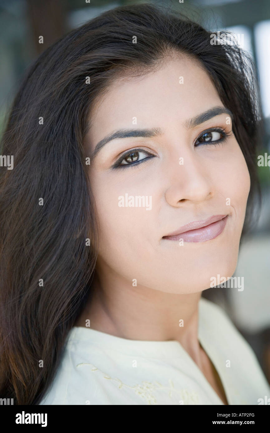 Portrait of a young woman smirking Stock Photo - Alamy