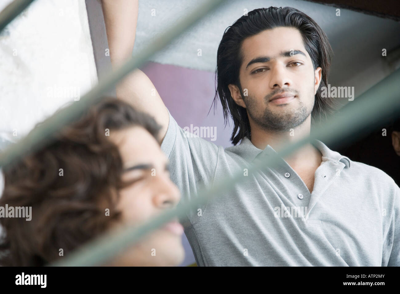 Portrait of a young man standing near another young man Stock Photo - Alamy