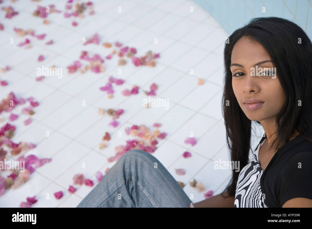 Portrait of a young woman sitting in an empty swimming pool Stock Photo ...