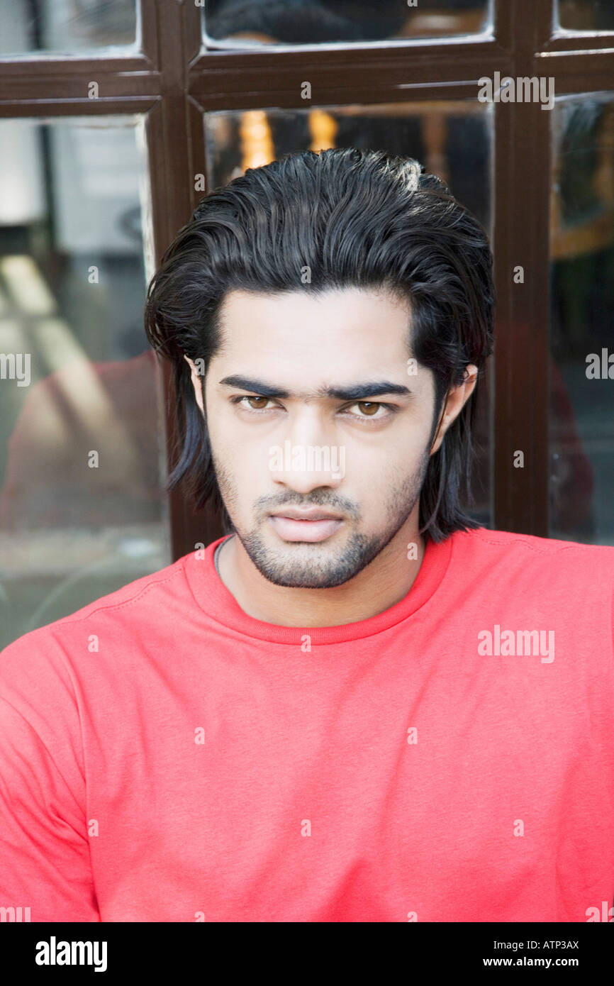 Portrait of a young man looking serious Stock Photo - Alamy