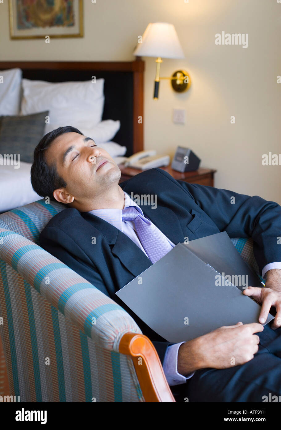 Businessman sleeping on a couch Stock Photo - Alamy