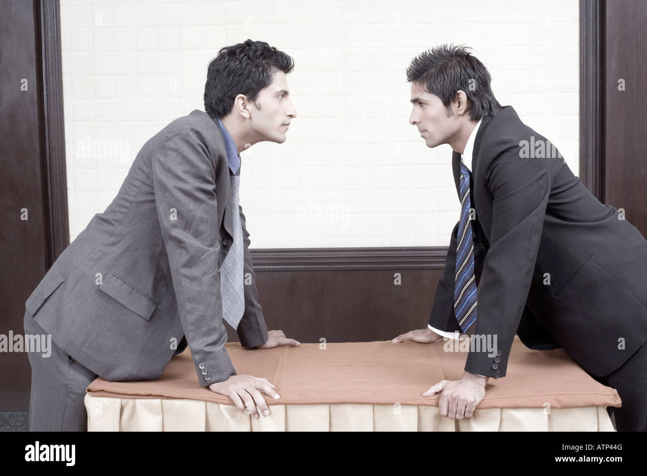 Side profile of two businessmen looking at each other Stock Photo - Alamy