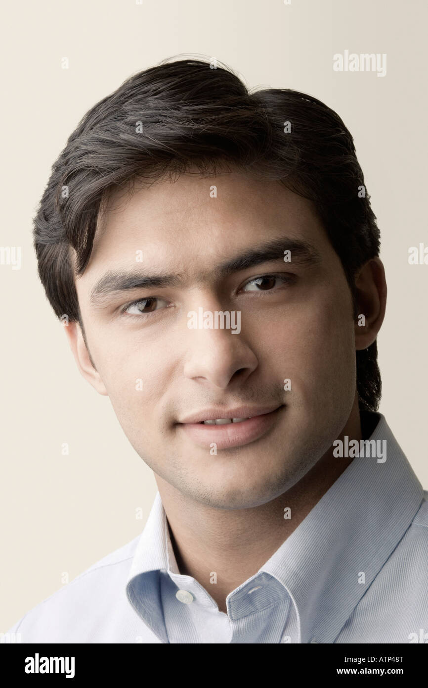Portrait of a young man smirking Stock Photo - Alamy