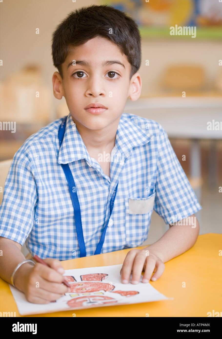 Portrait of a schoolboy drawing on a sheet of paper Stock Photo - Alamy
