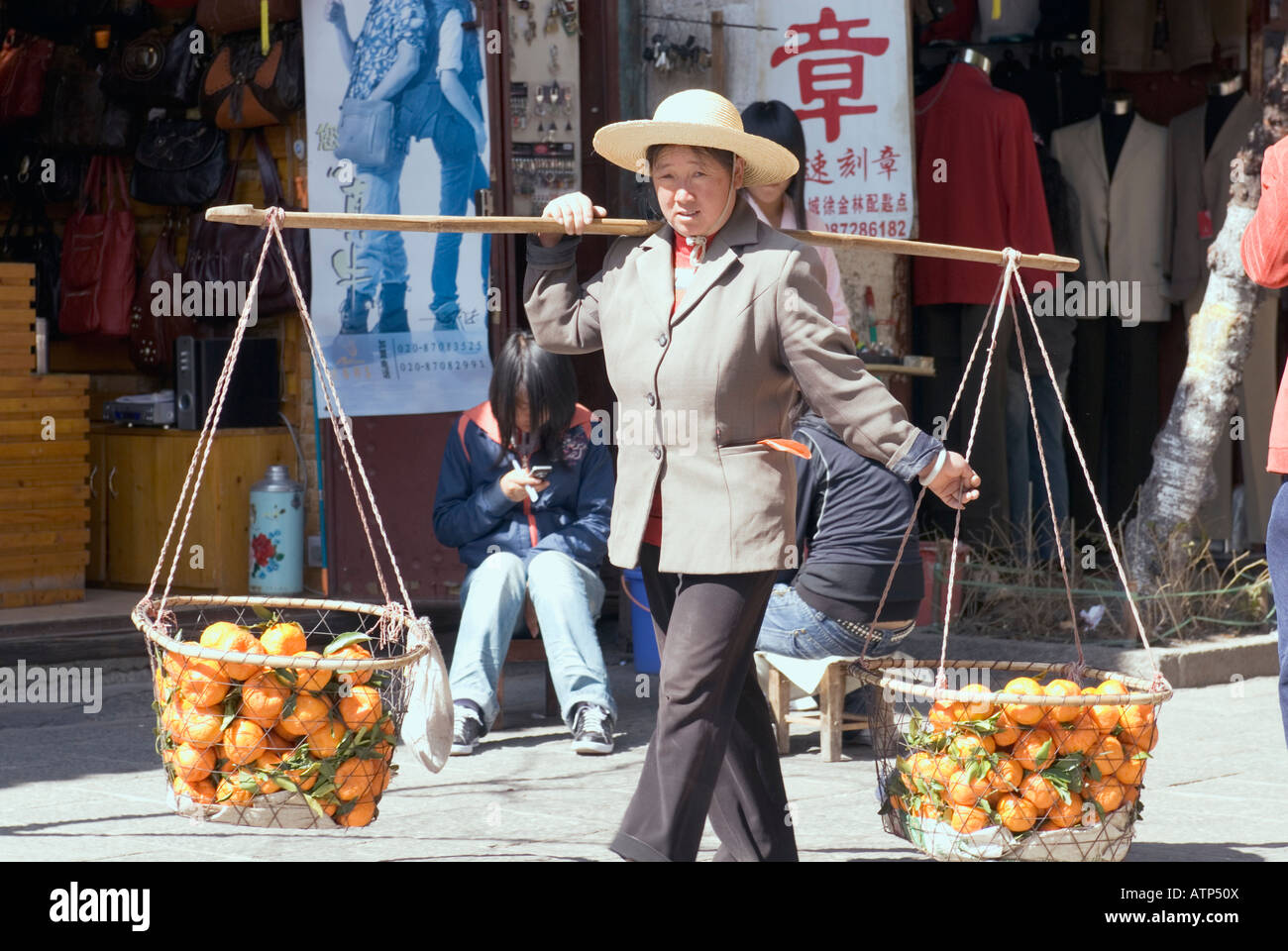 China, Chinese Woman Carrying A Pole Over Her Shoulder With Baskets Of ...