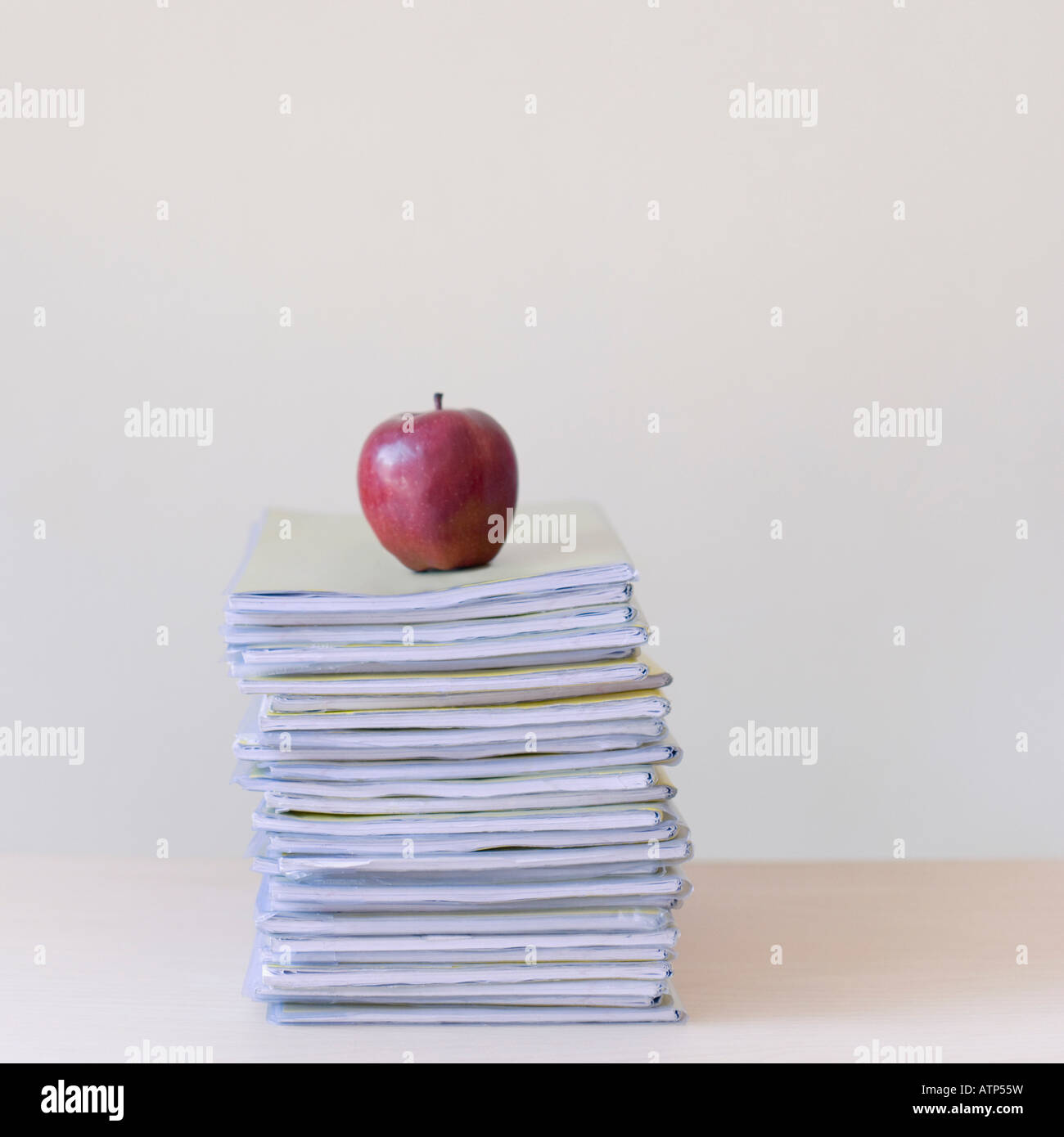 Apple on a stack of books Stock Photo - Alamy