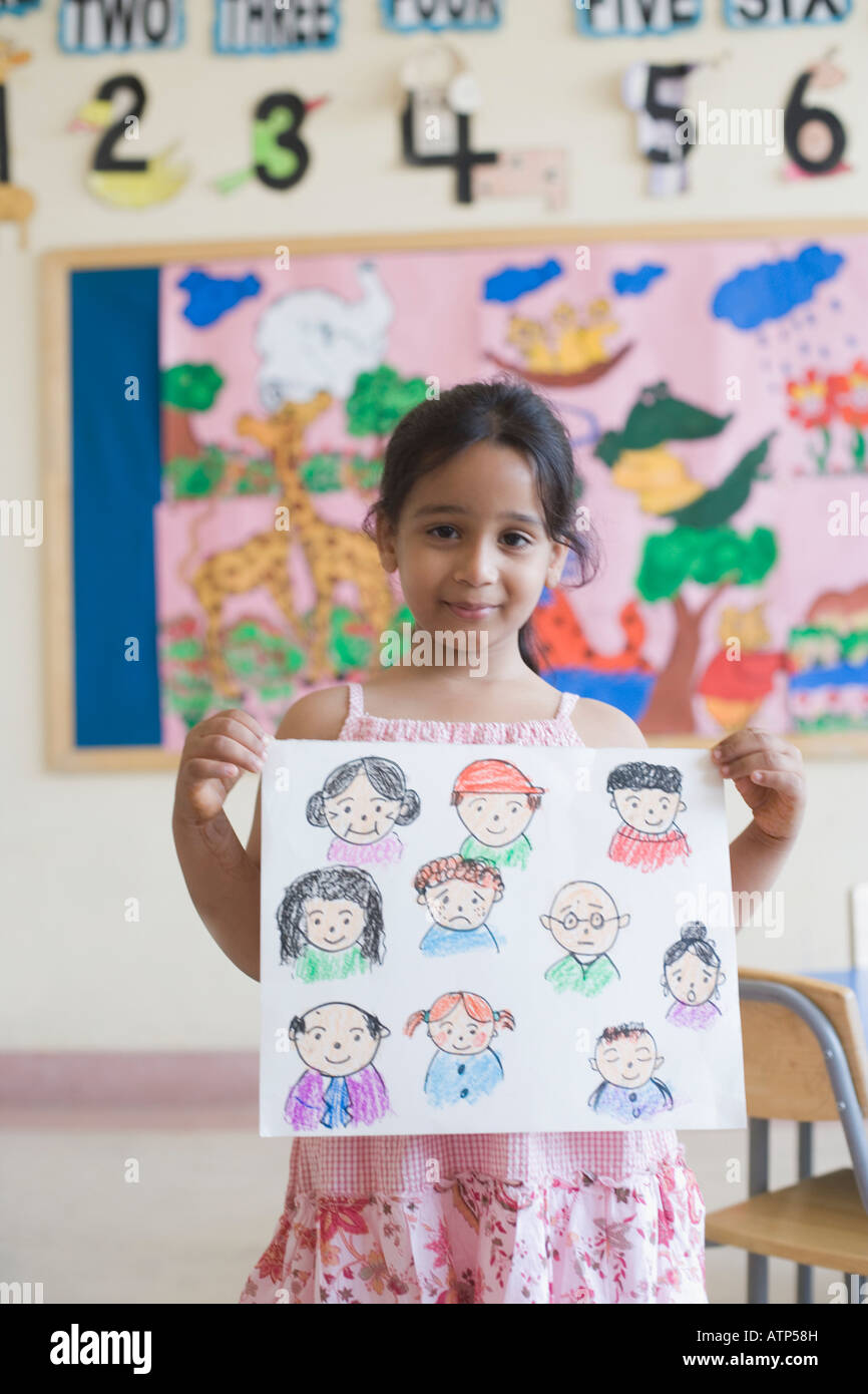 Portrait of a girl showing a drawing and smiling Stock Photo - Alamy