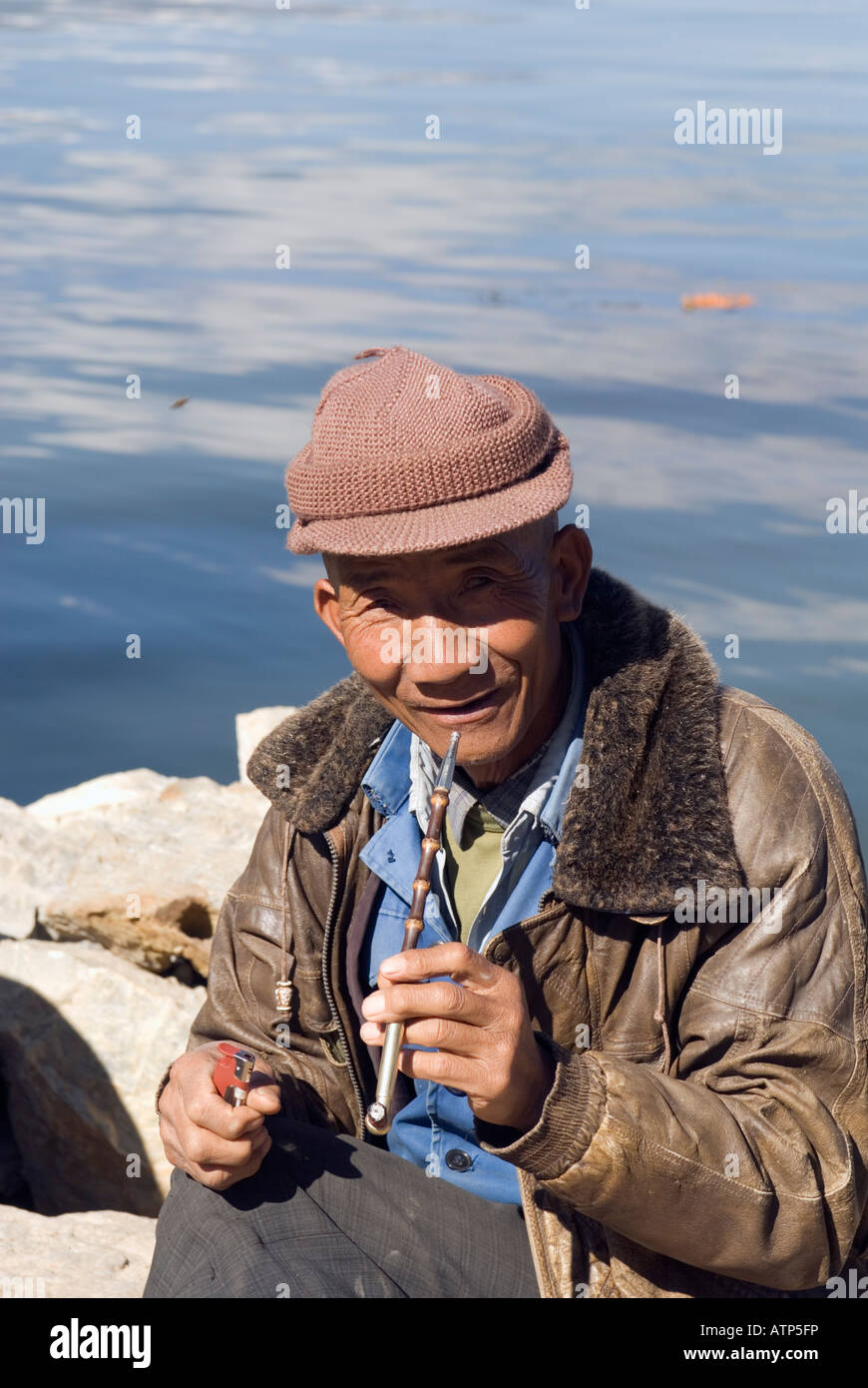 Old chinese man smoking pipe hi-res stock photography and images - Alamy