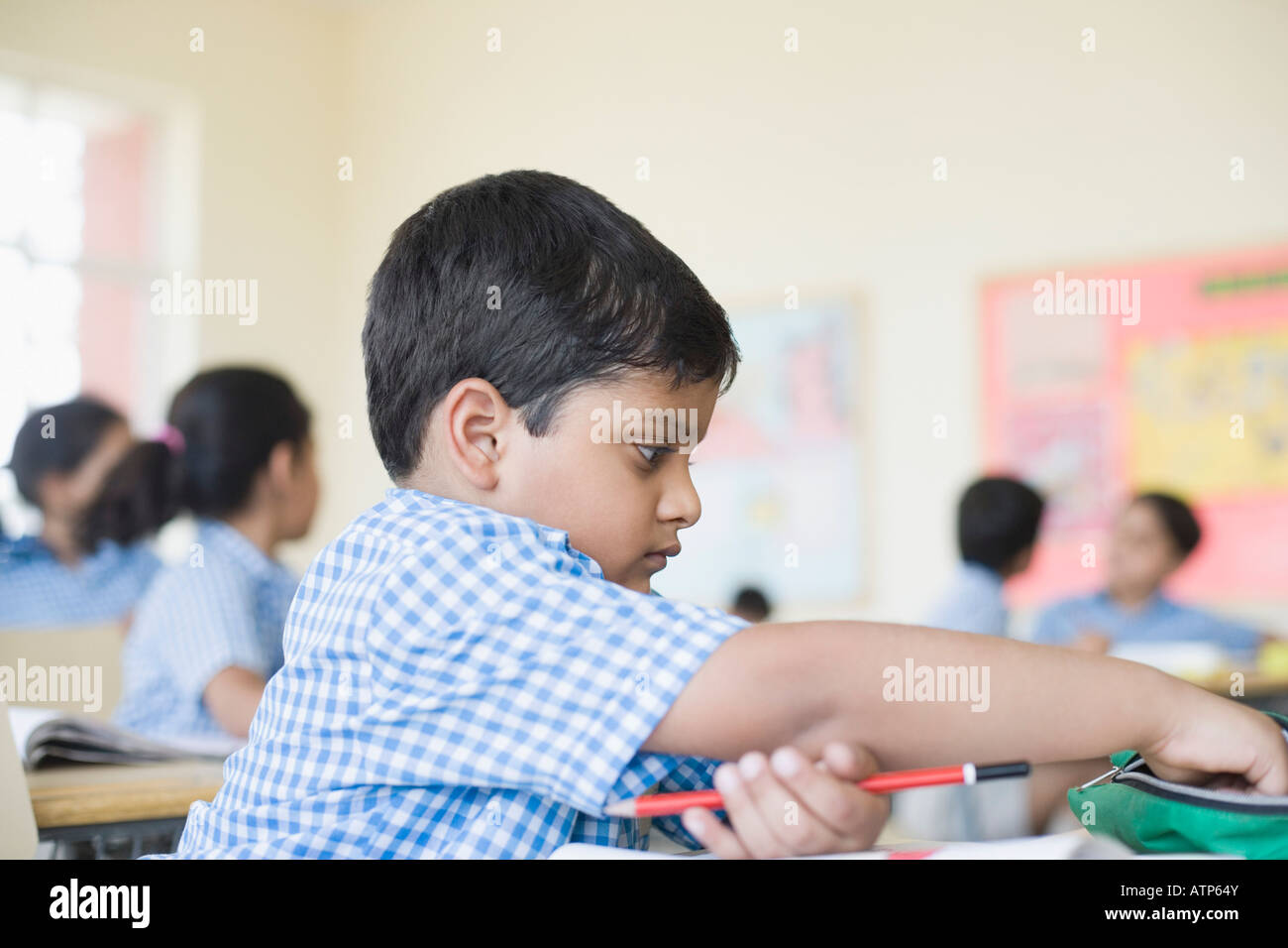 Side profile of a schoolboy in a classroom Stock Photo - Alamy