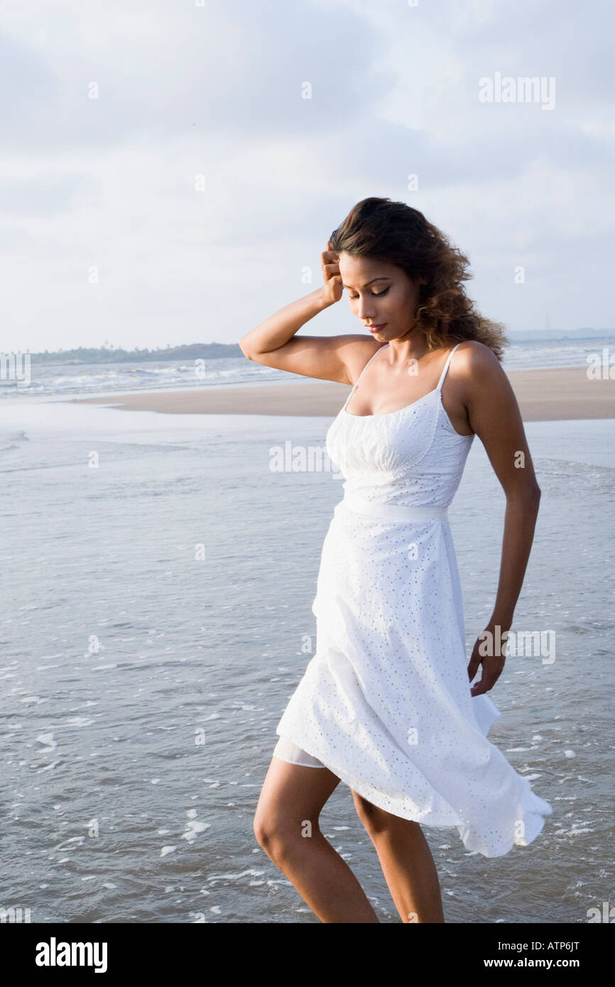 Side profile of a young woman standing on the beach Stock Photo - Alamy