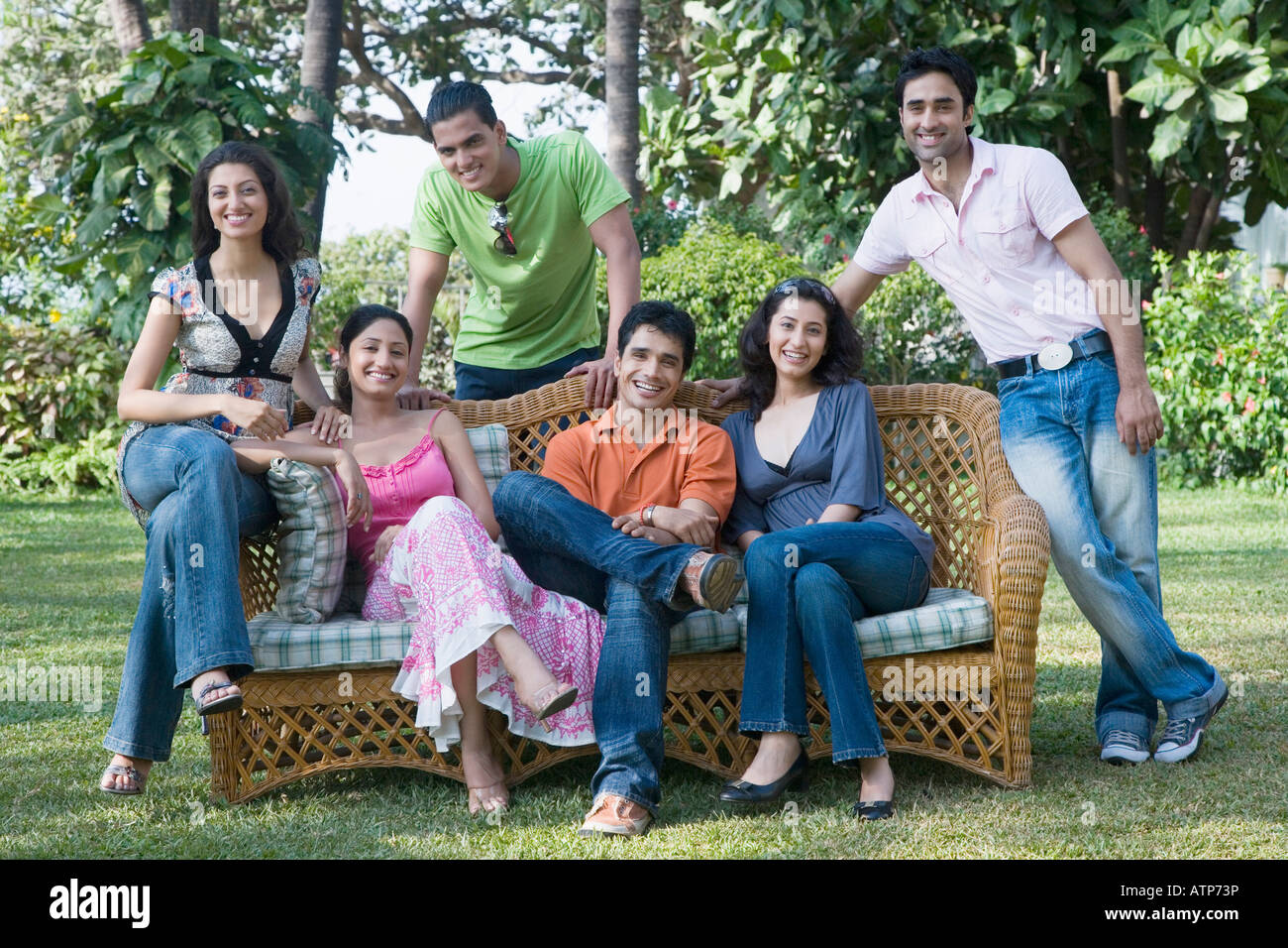 Three young couples smiling in a lawn Stock Photo - Alamy