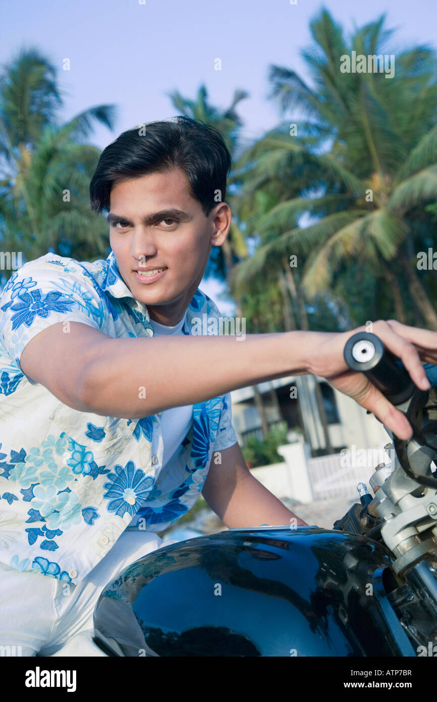 Portrait of a young man riding a motorcycle Stock Photo - Alamy