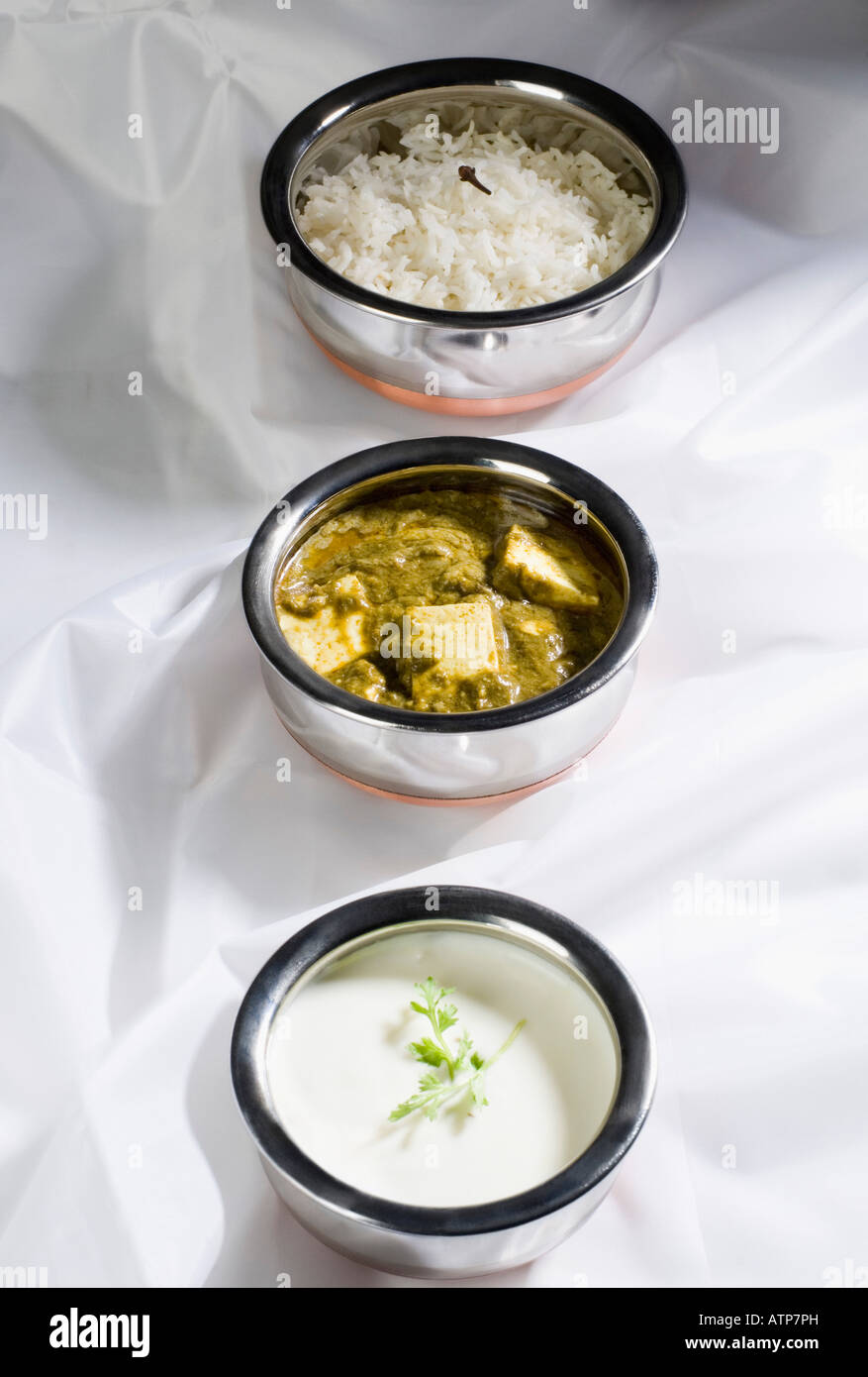 High angle view of three bowls of shahi paneer with curd and rice Stock ...