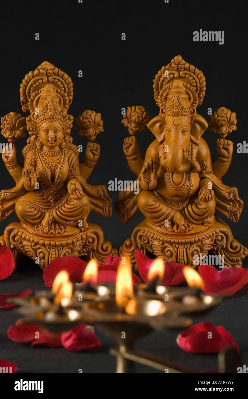 Close-up of an oil lamp burning in front of religious idols Stock Photo ...
