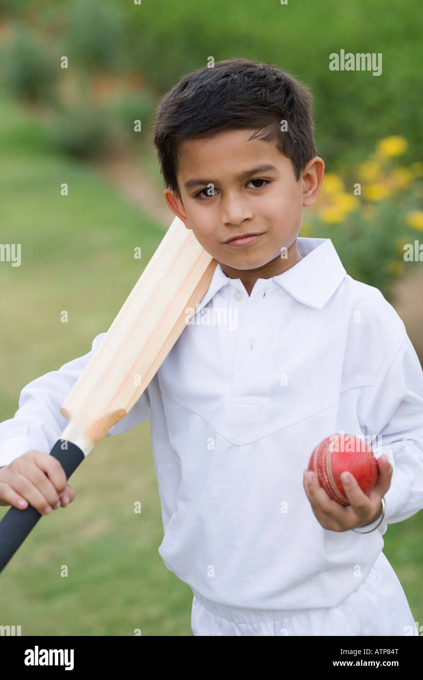 Boy holding cricket bat ball hi-res stock photography and images - Alamy