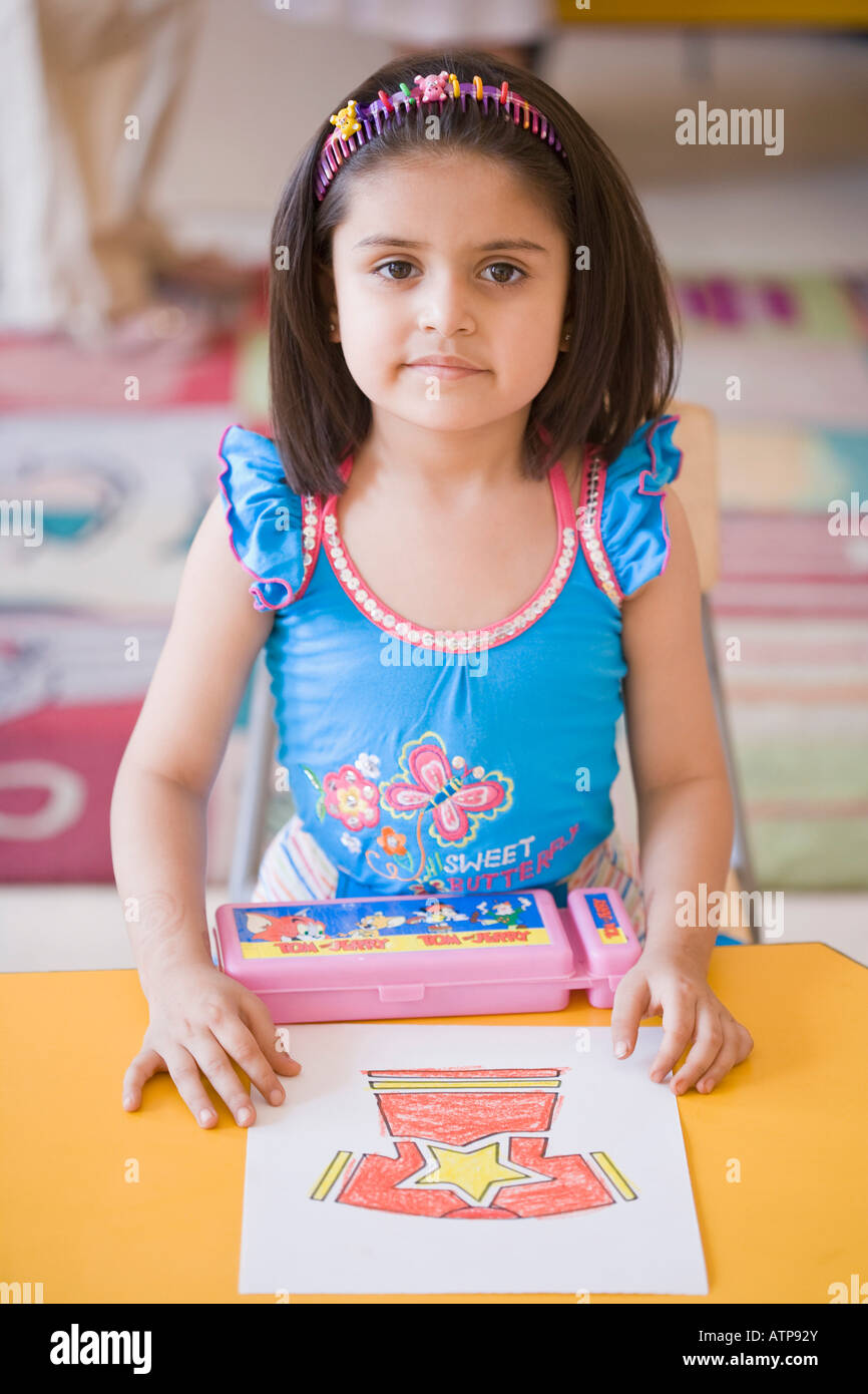 Portrait of a girl with her drawing in the classroom Stock Photo - Alamy