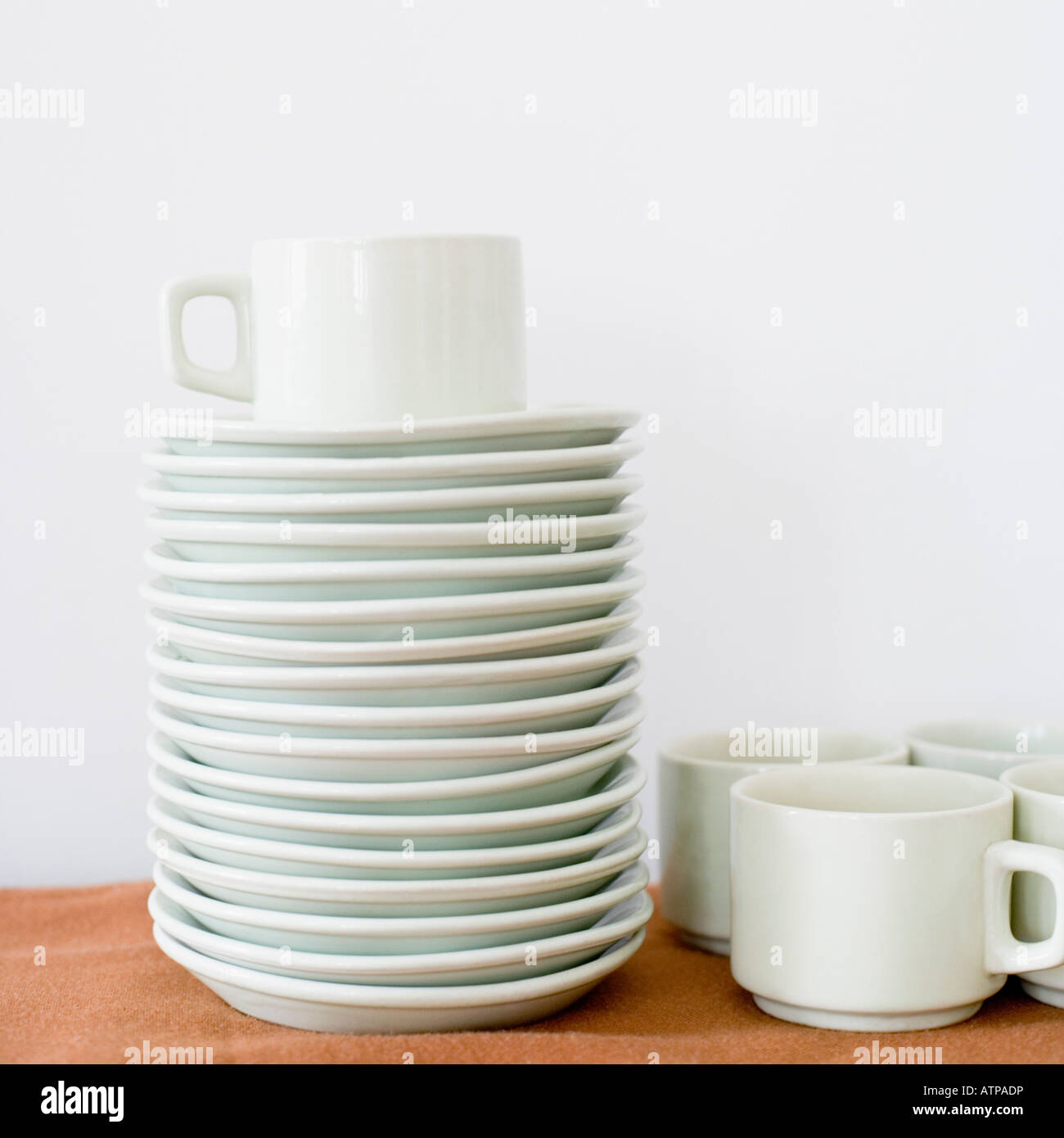 Close-up of a stack of saucers with cups Stock Photo - Alamy