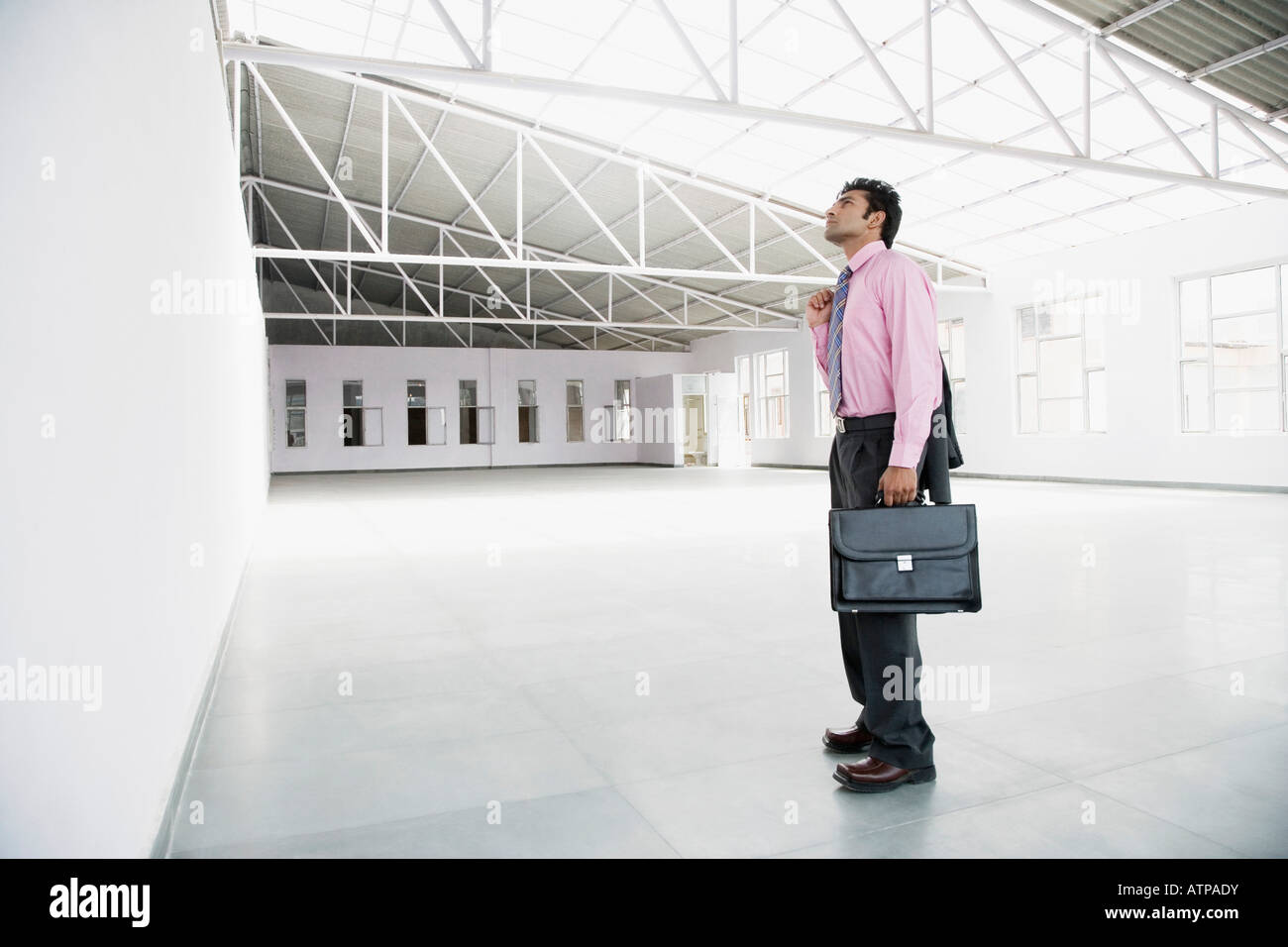 Side profile of a businessman holding a briefcase Stock Photo - Alamy
