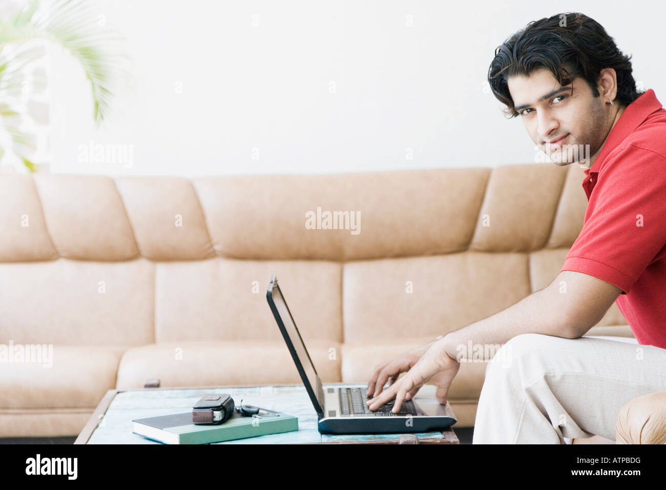 Portrait of a young man using a laptop Stock Photo - Alamy