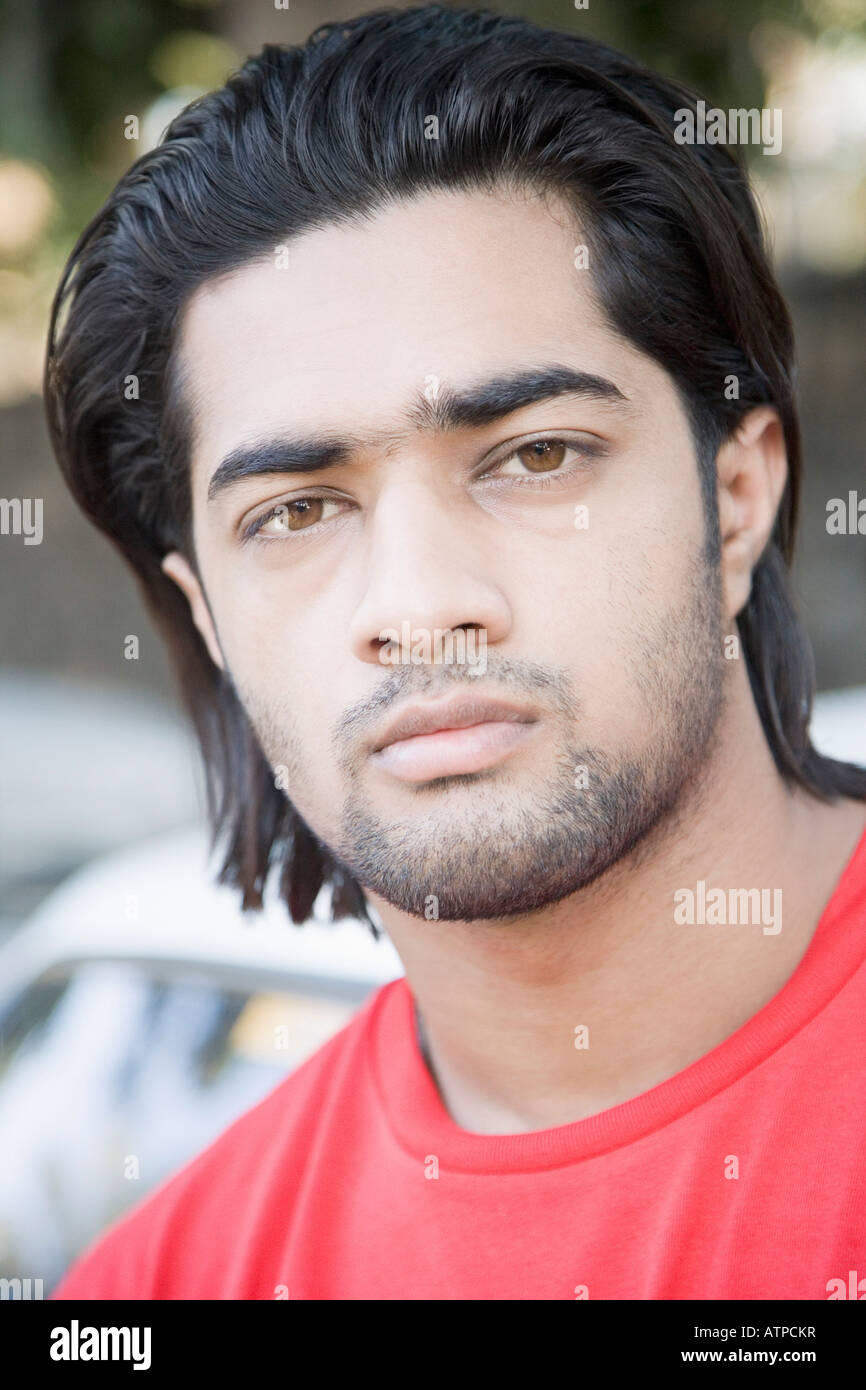 Portrait of a young man looking serious Stock Photo - Alamy