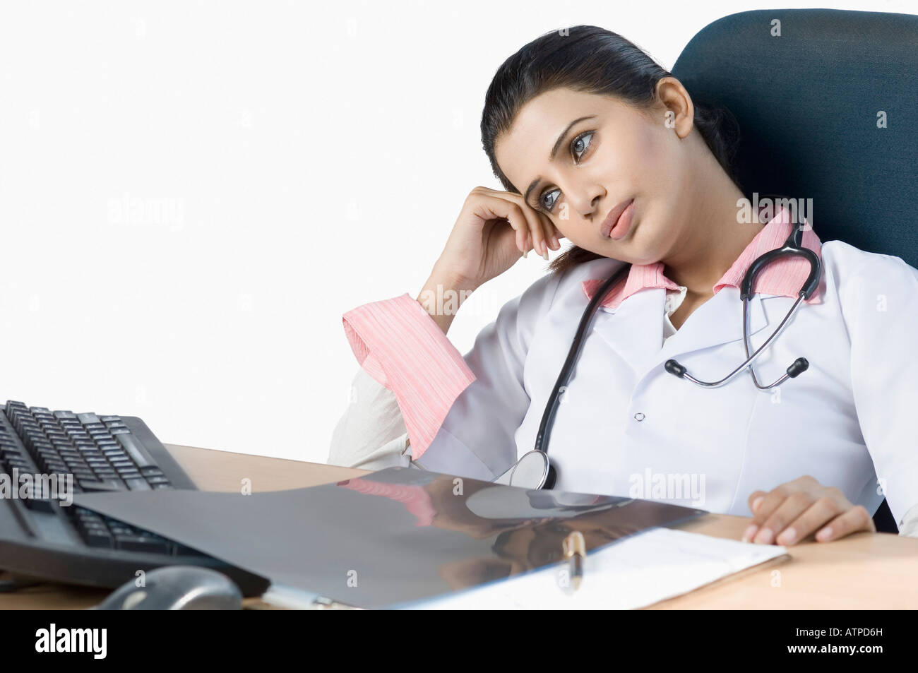Close-up of a female doctor thinking in an office Stock Photo - Alamy