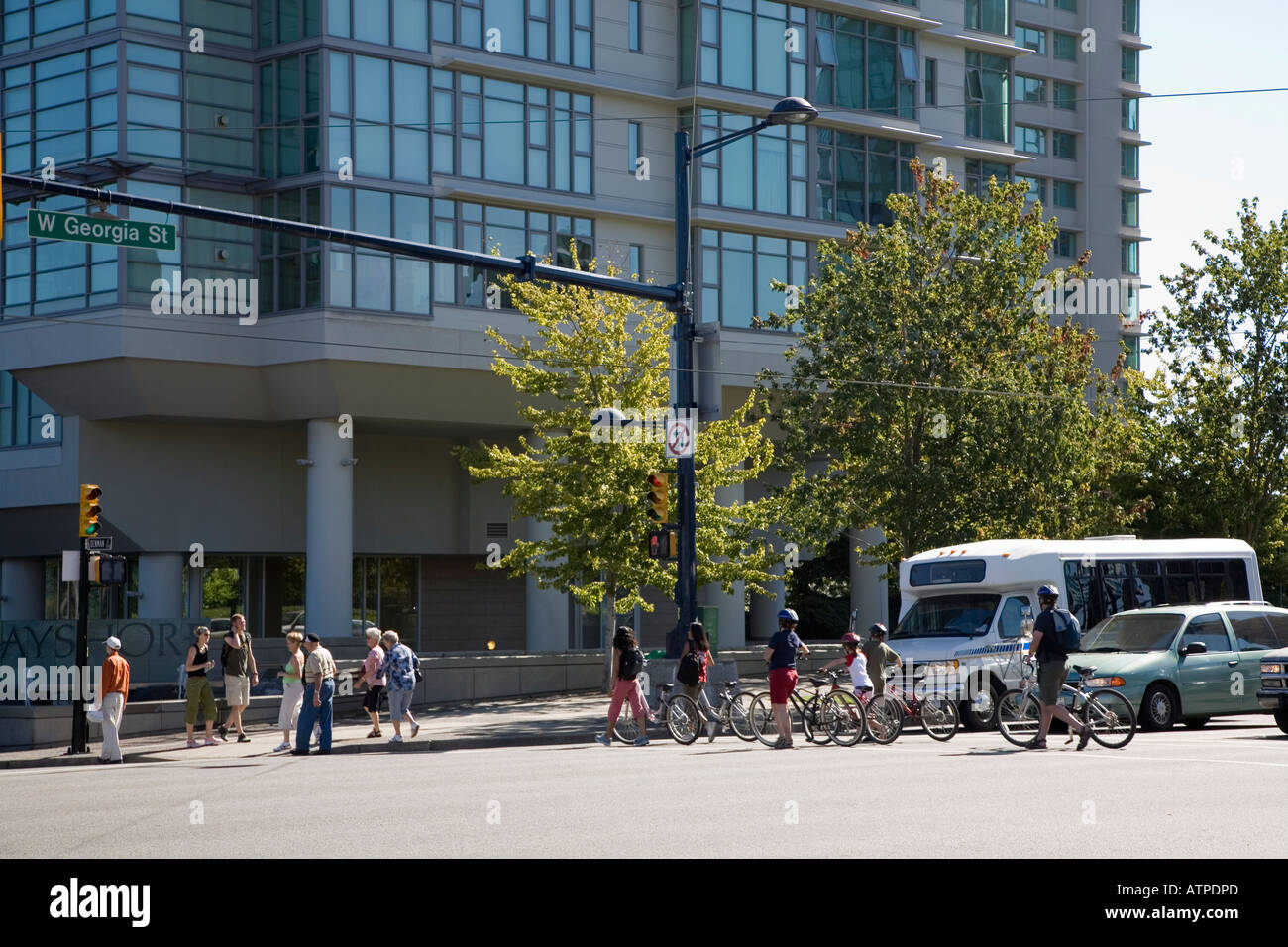 People with bicycles walking on pedestrian crossing at street junction ...