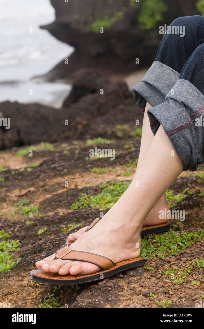 Low section view of a person's legs wearing flip-flops Stock Photo - Alamy