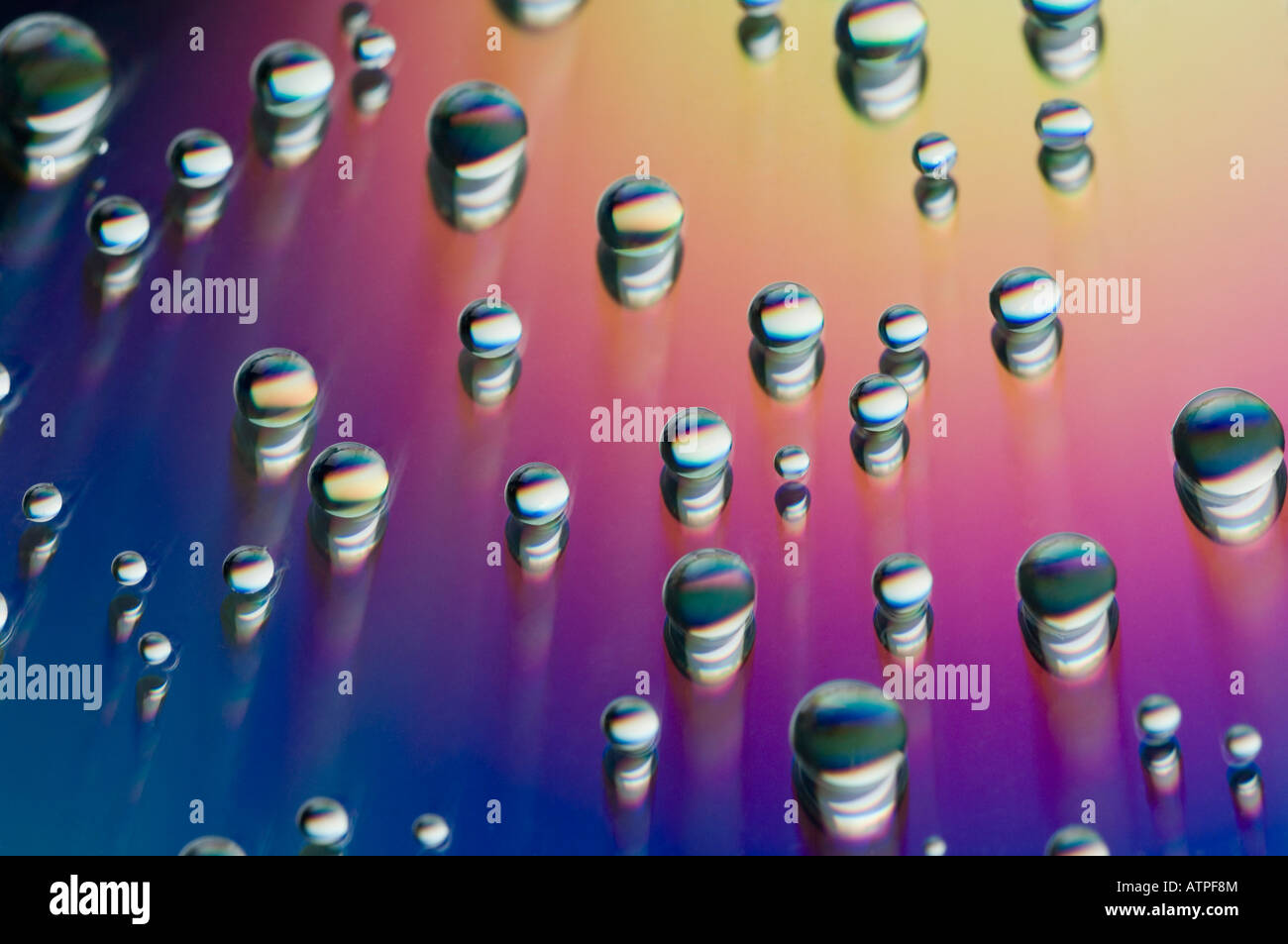 Close-up of water drops on a multi-colored surface Stock Photo - Alamy