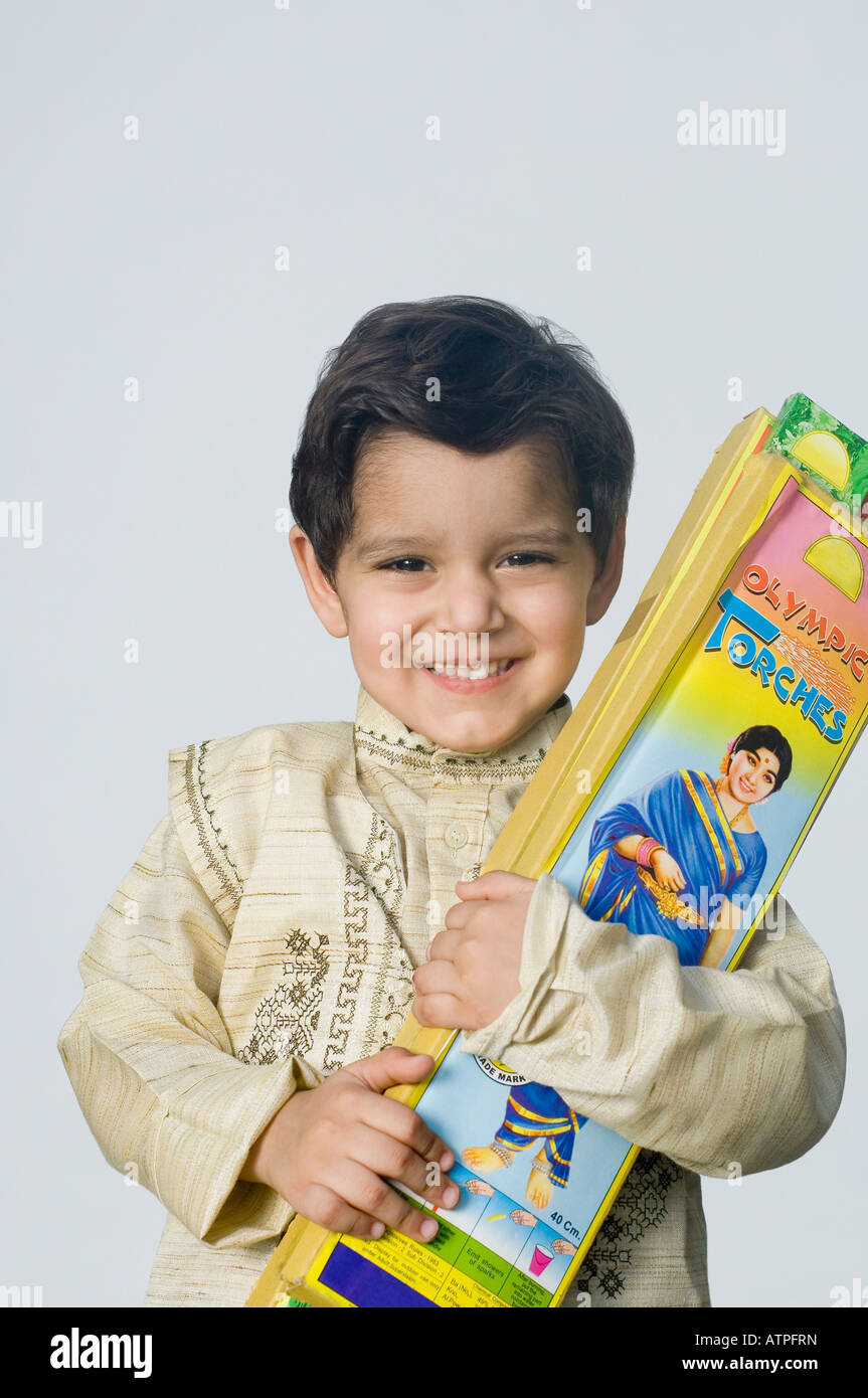 Portrait of a boy holding packets of firecracker Stock Photo - Alamy