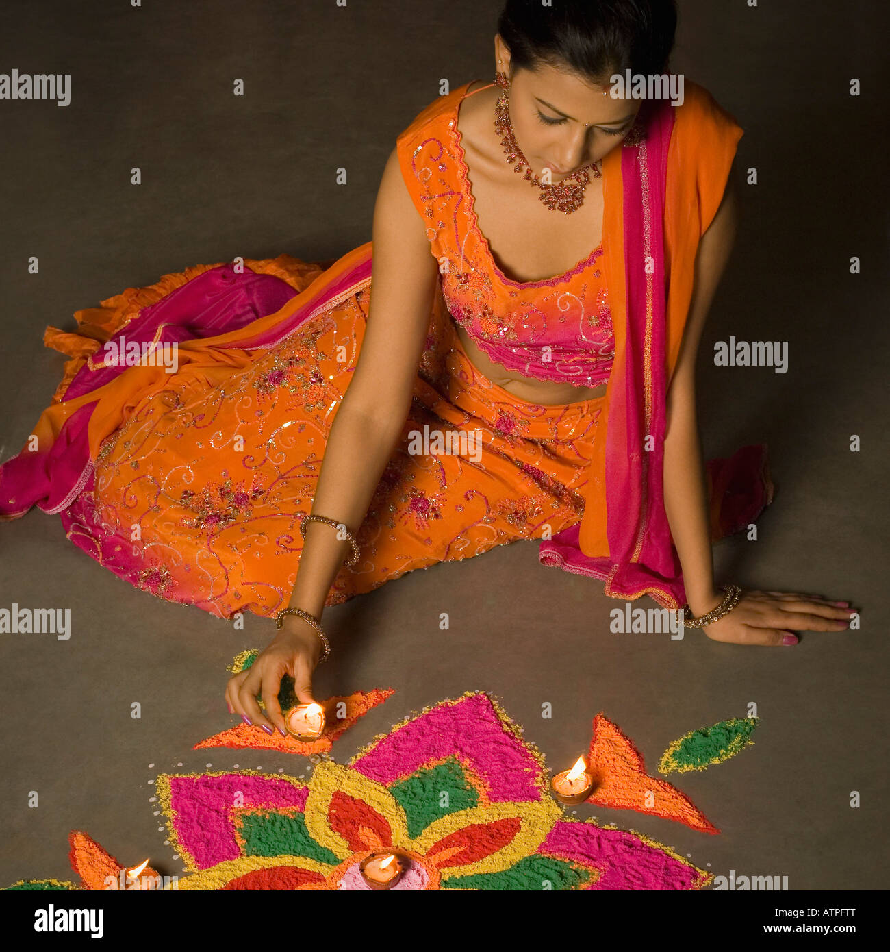 Indian woman making rangoli festival hi-res stock photography and ...