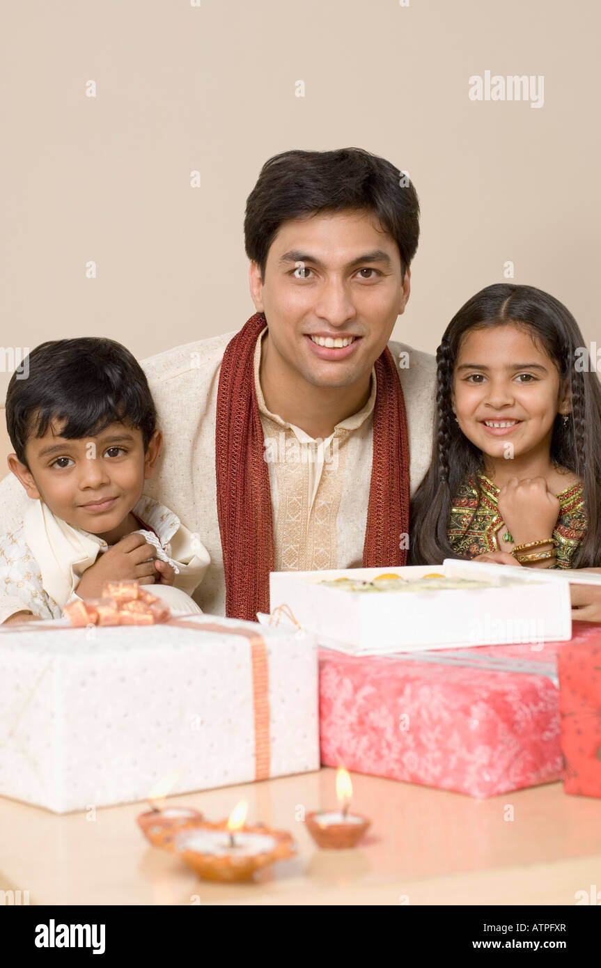 Young man smiling with his children Stock Photo - Alamy