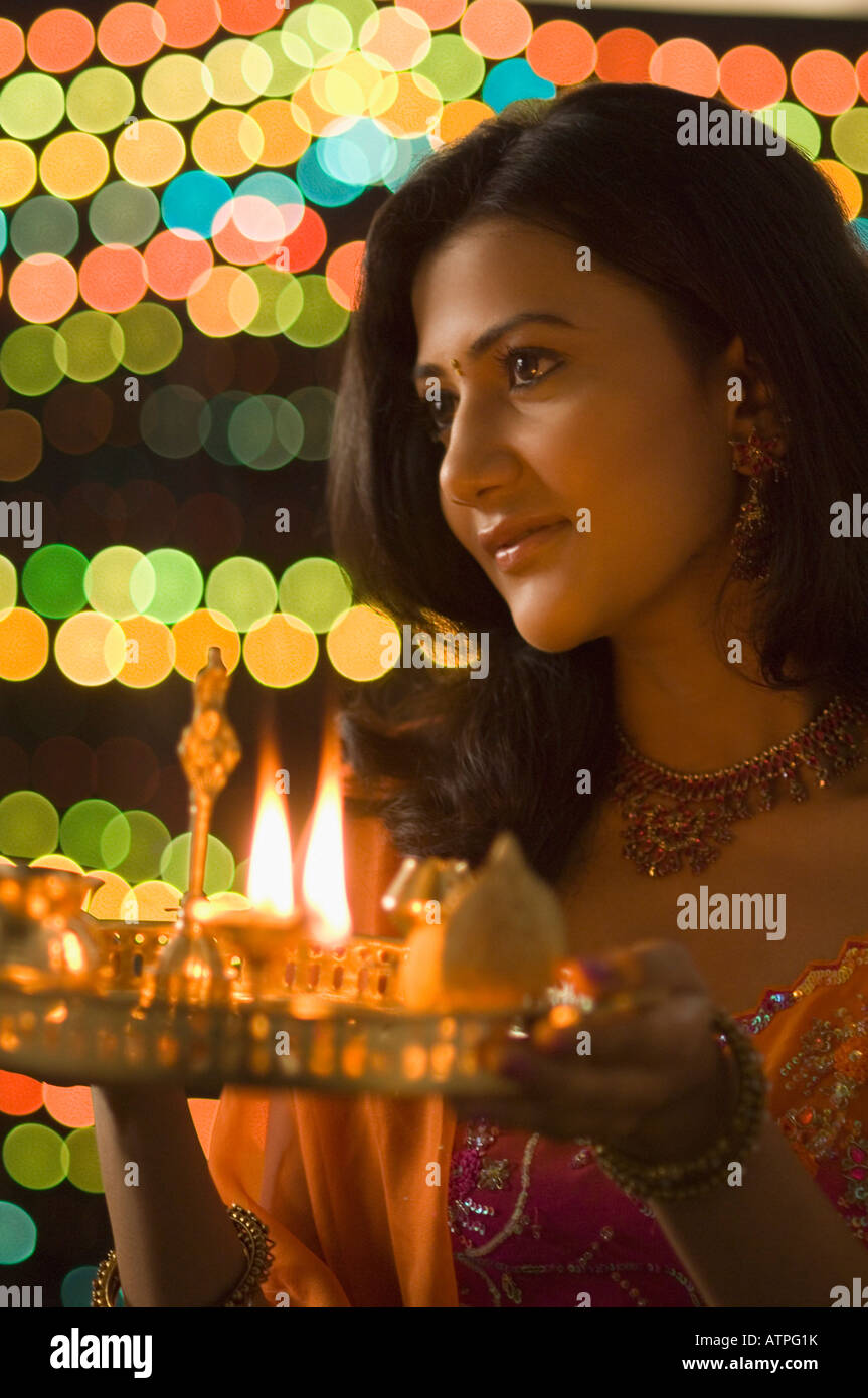 Close-up of a young woman holding a diwali thali Stock Photo - Alamy