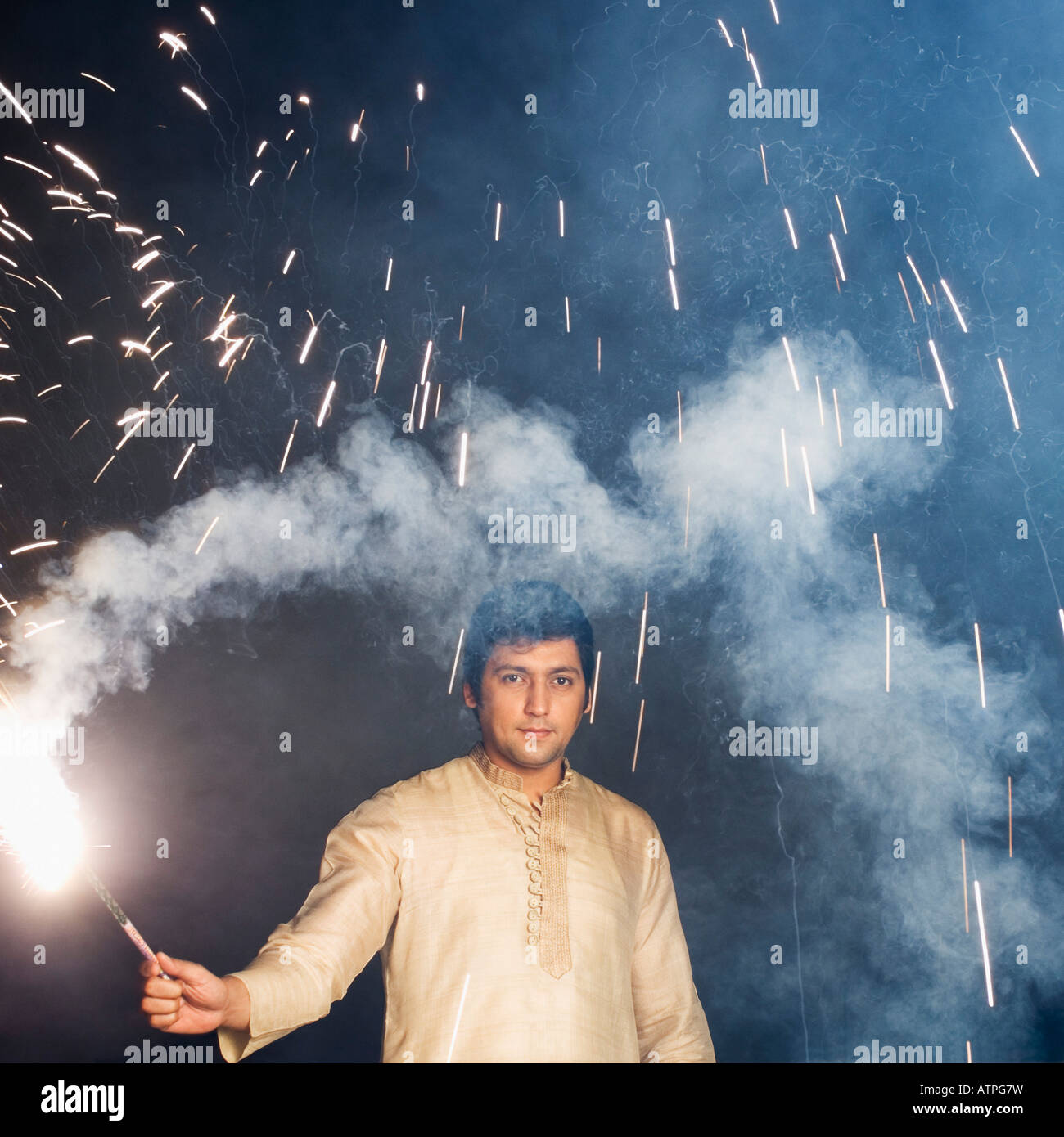 Portrait of a mid adult man burning firecrackers Stock Photo - Alamy