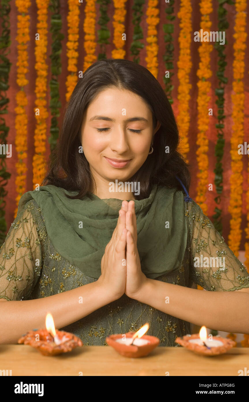Woman praying oil lamp in hi-res stock photography and images - Alamy