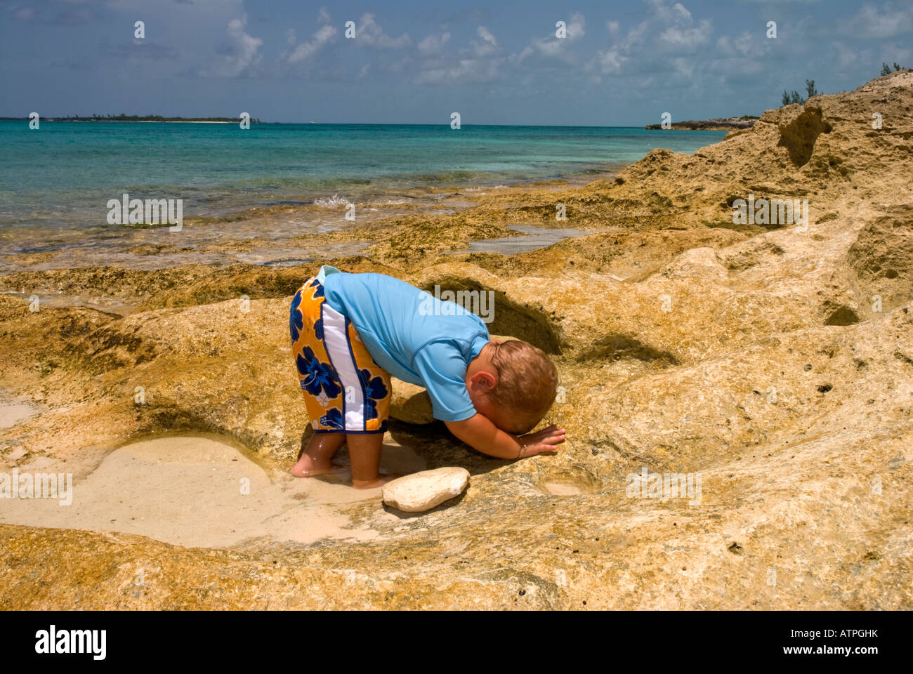 Little boy playing on rocks, Rose Island, Bahamas Stock Photo - Alamy