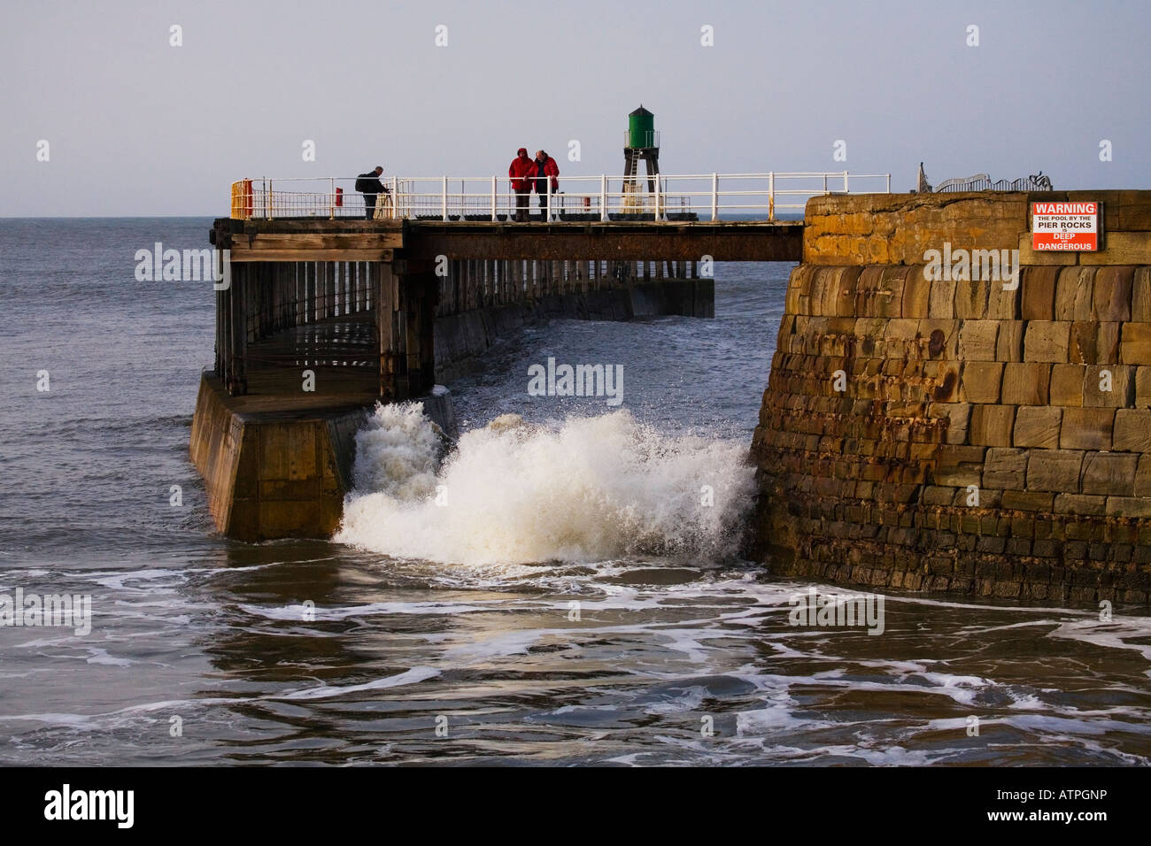 watching waves on whitby pier Stock Photo - Alamy