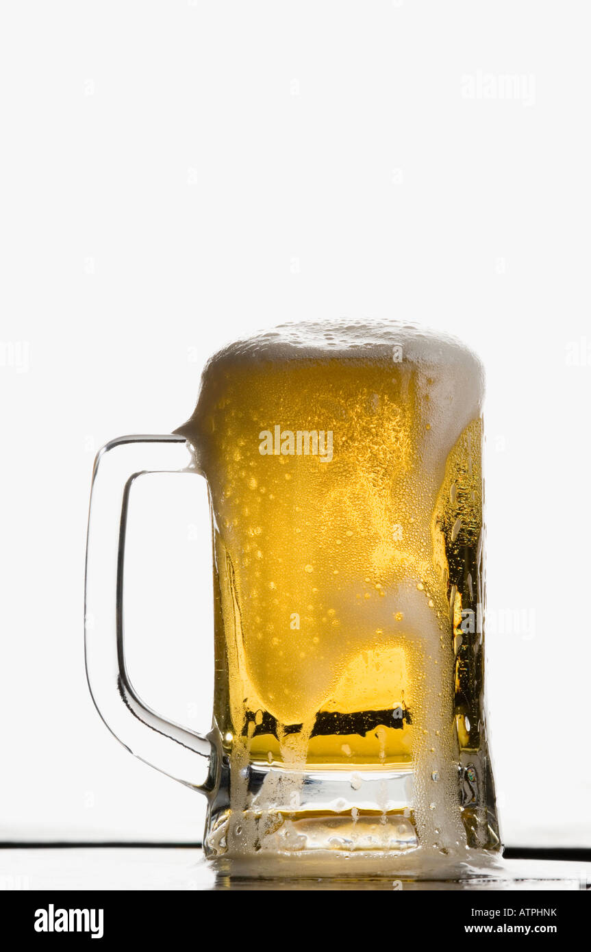 Close-up of beer spilling out of a glass Stock Photo - Alamy