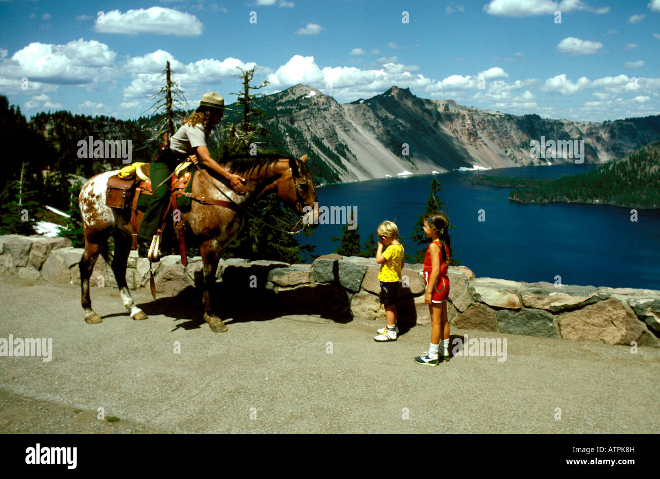 OR Oregon Crater Lake National Park NPS female ranger on horseback ...