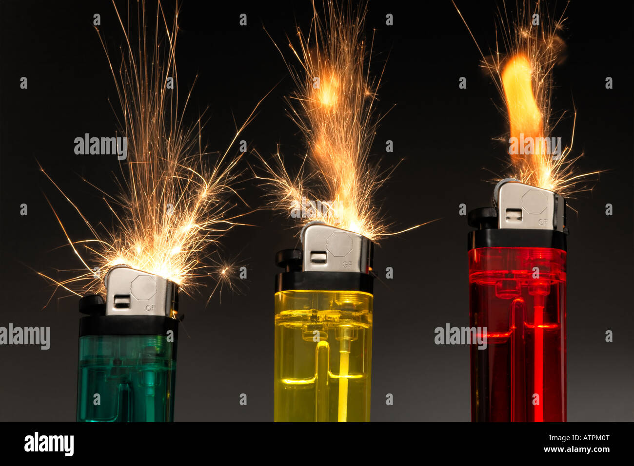 Lighters shooting flames and sparks Stock Photo - Alamy