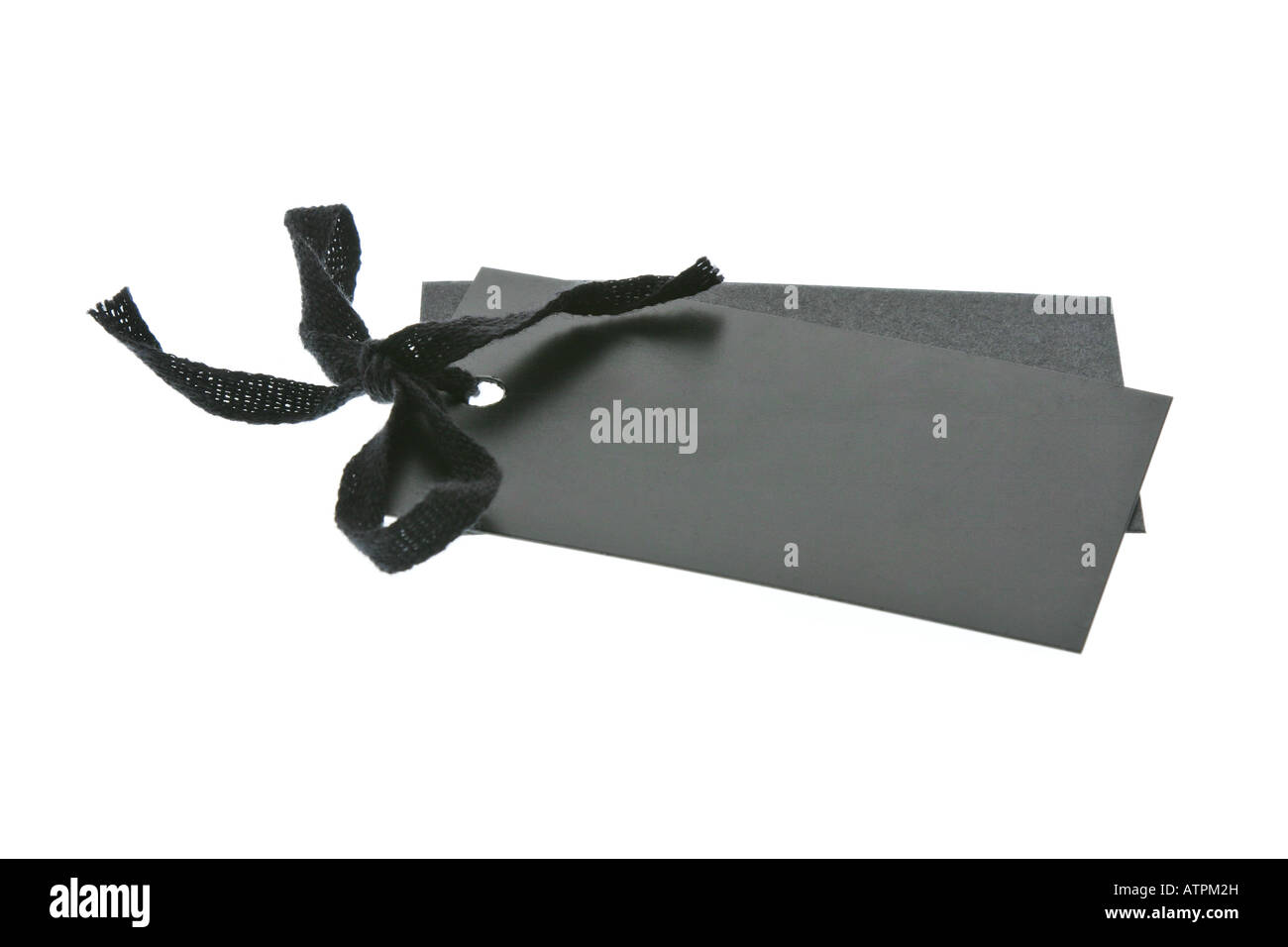 Black tags fastened with ribbon on white background Stock Photo - Alamy
