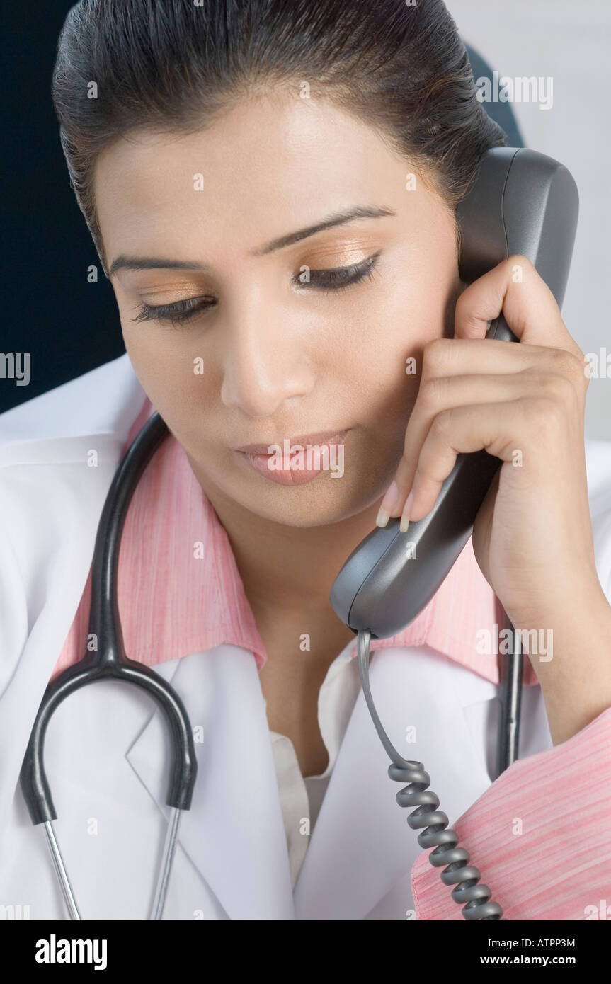 Close-up of a female doctor talking on the telephone Stock Photo - Alamy