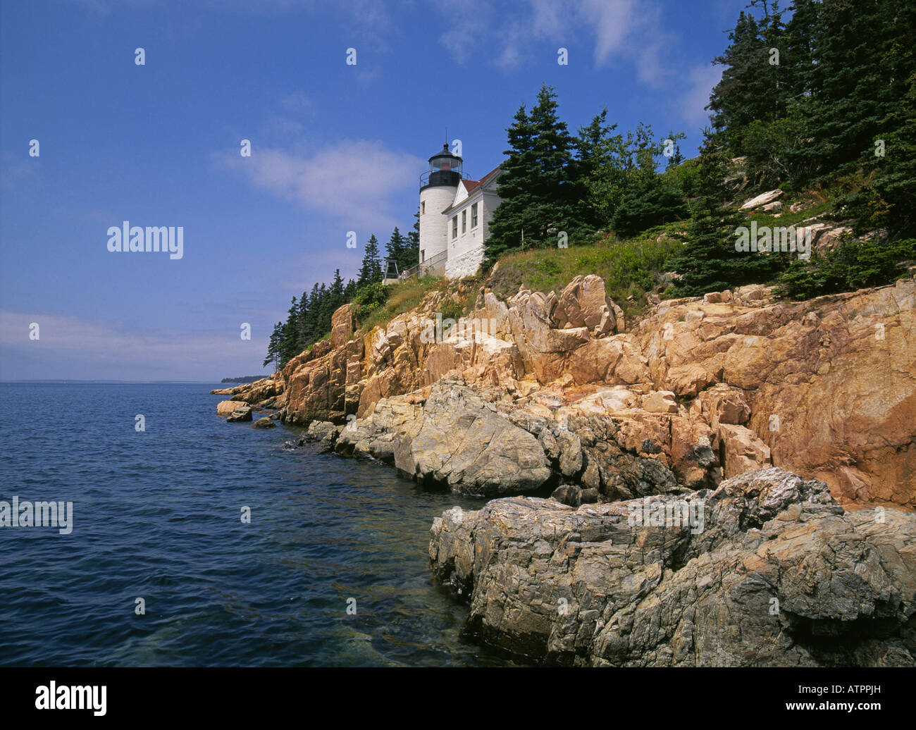 A view of a rocky shoreline and Bass Harbor Lighthouse in the Mount ...